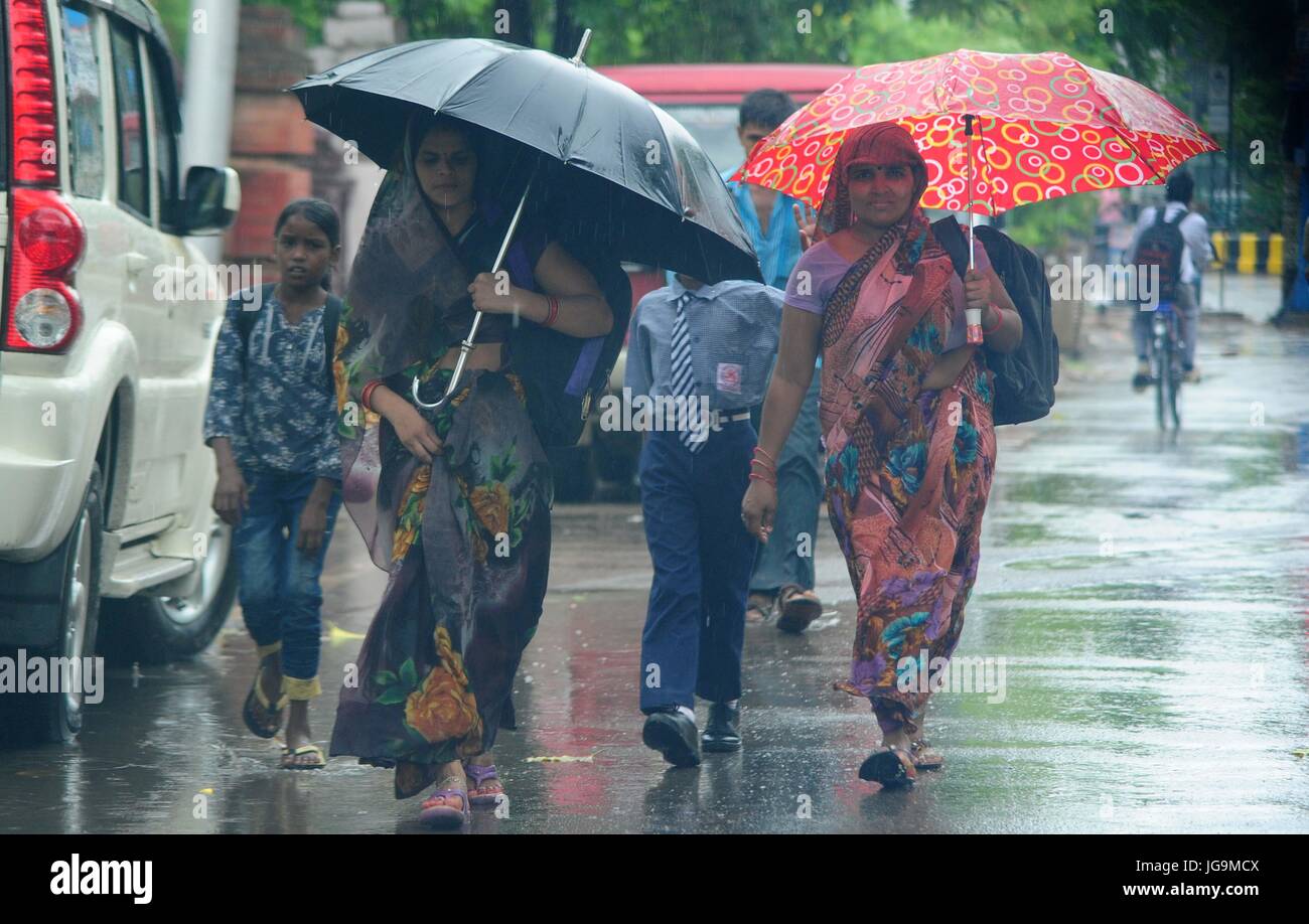 Allahabad, India. 04th July, 2017. People use umbrella to being safe ...