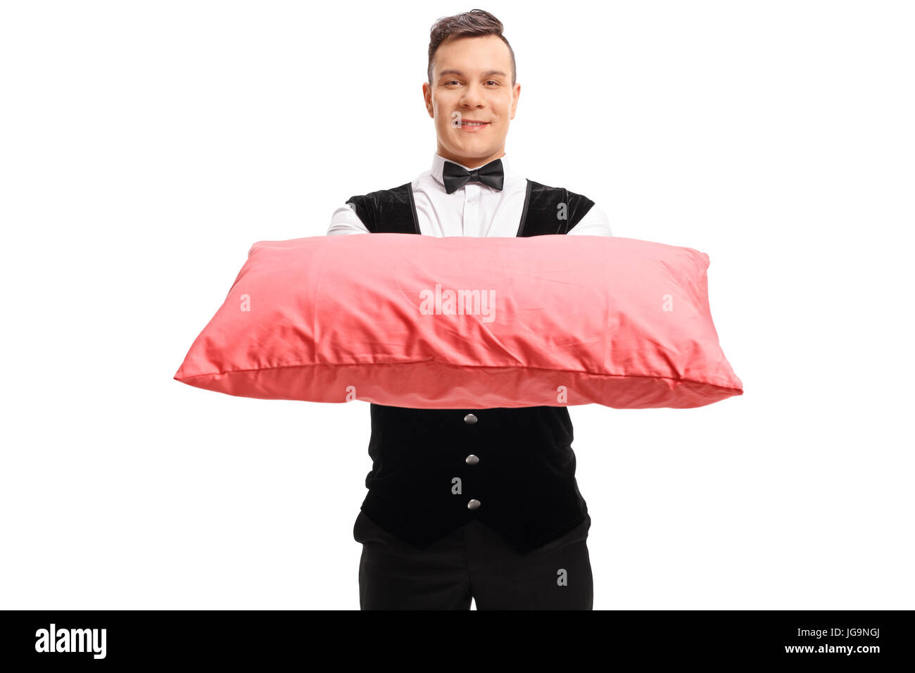 Butler serving a pillow isolated on white background Stock Photo - Alamy