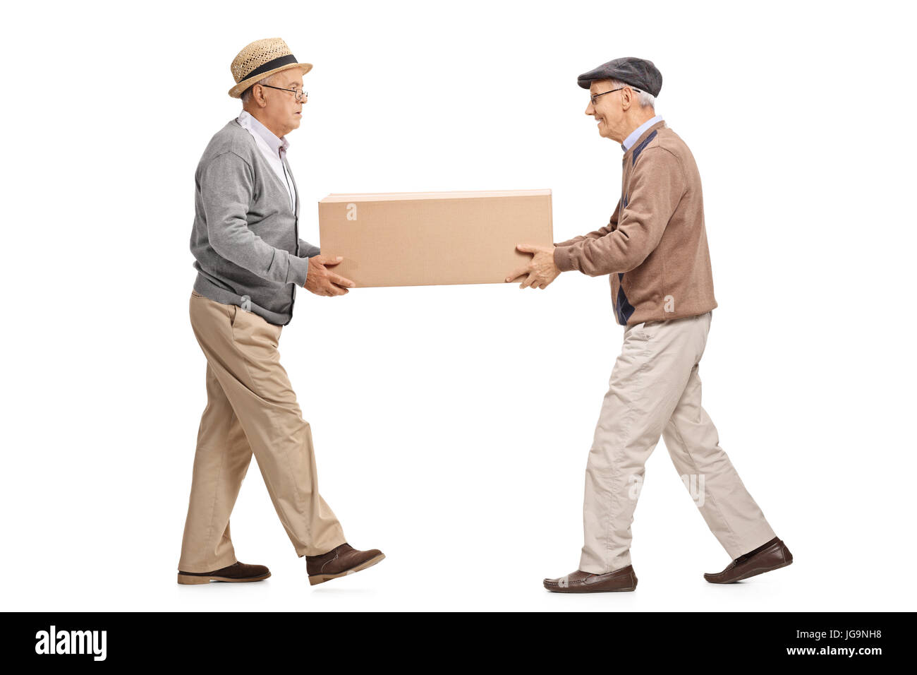 Full length profile shot of two mature men carrying a big cardboard box ...