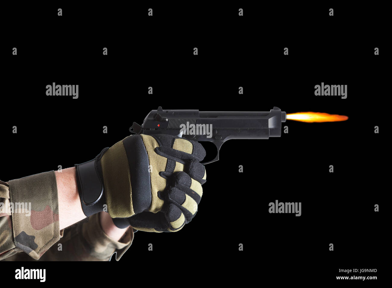 Shooting with a gun on black background Stock Photo - Alamy