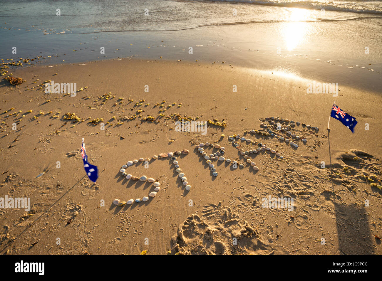 Straya text drawn using shells on sand. Straya is an abbreviation of ...