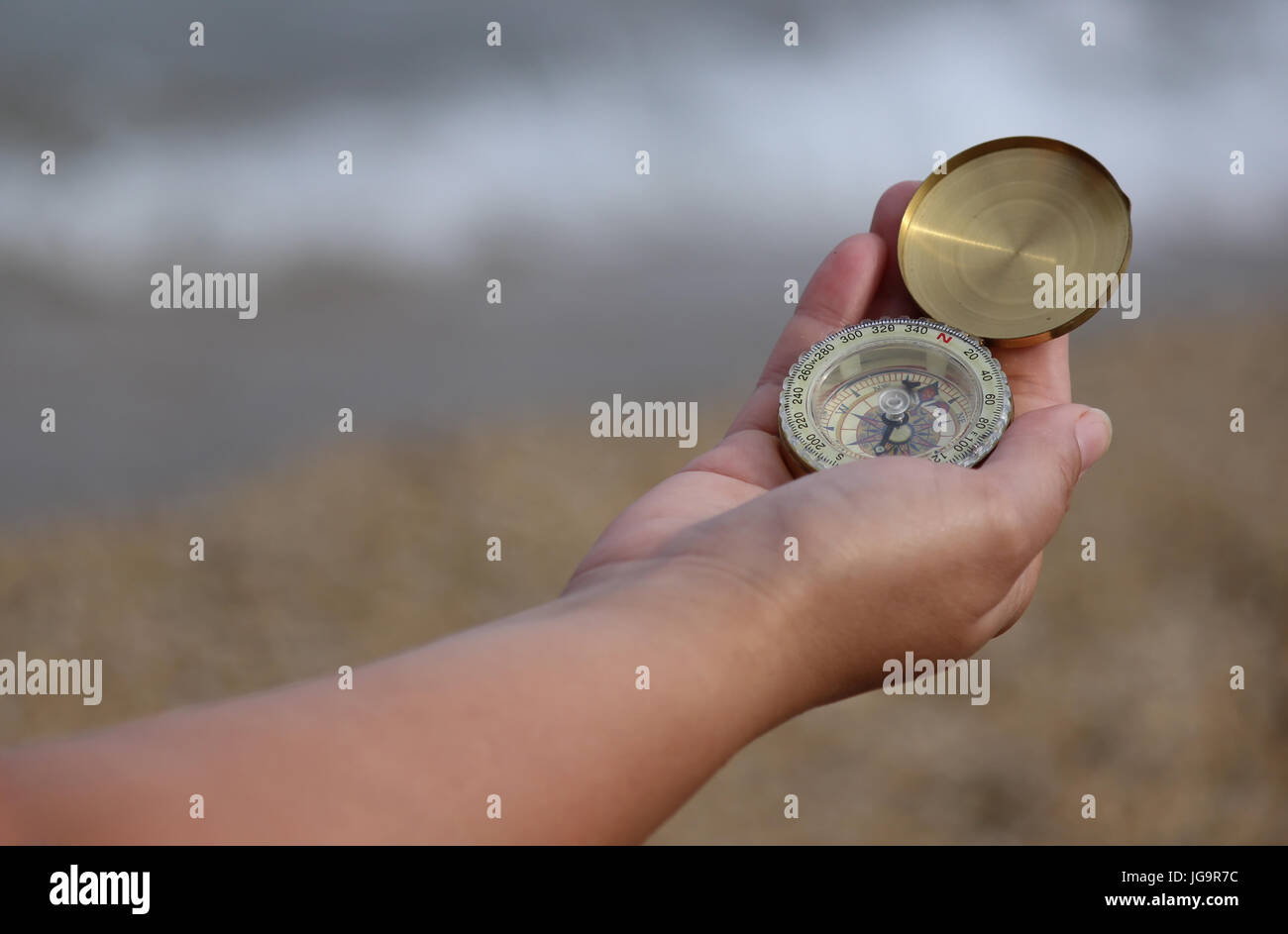 Compass in hand Stock Photo - Alamy