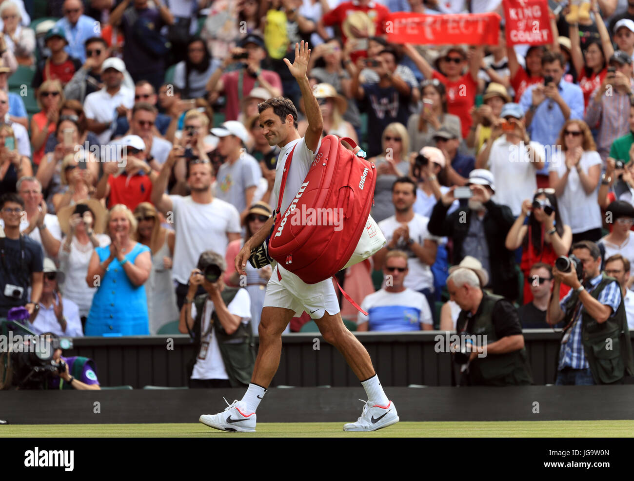Roger Federer waves to the crowd on centre court following his victory ...