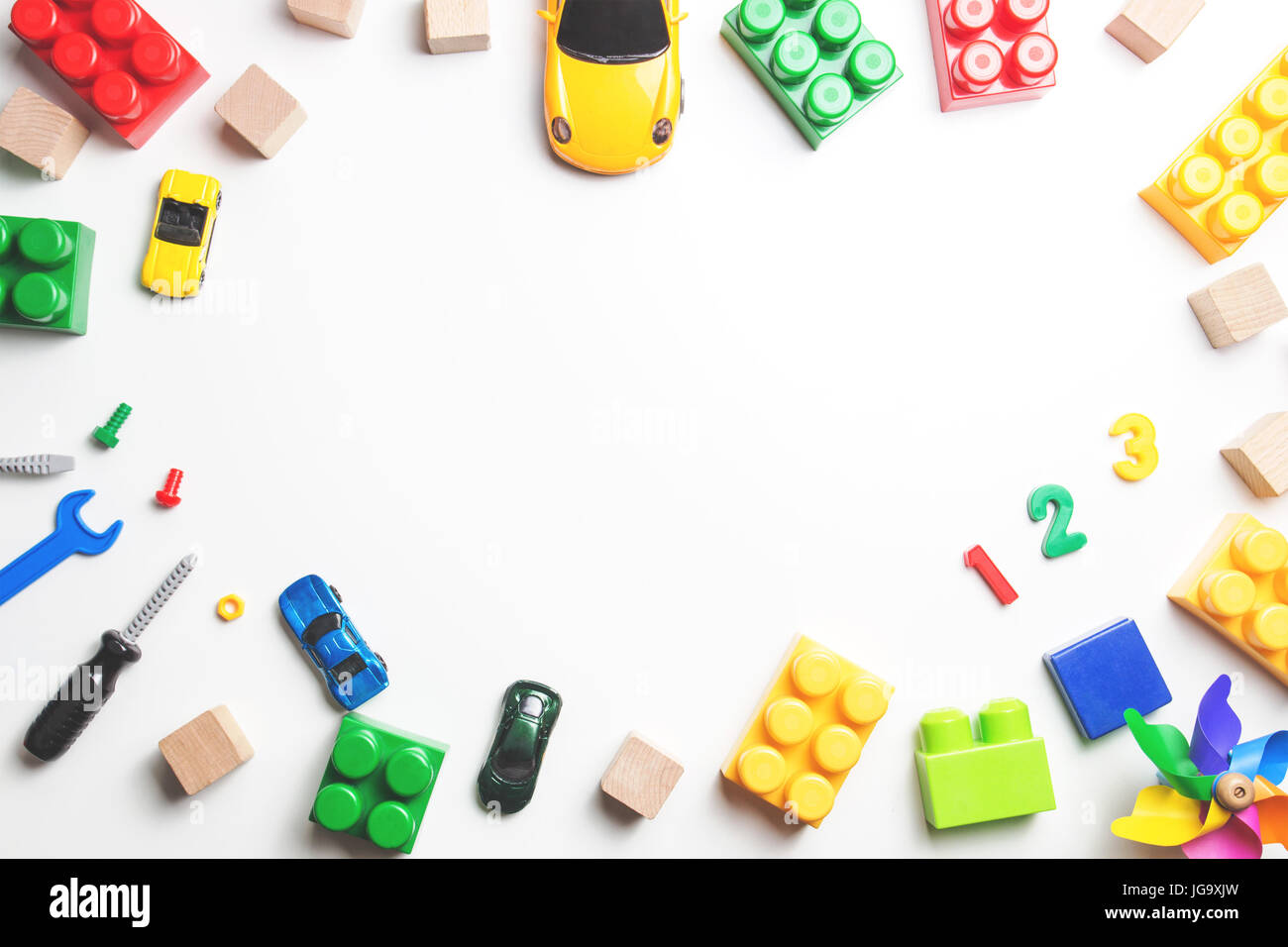 Kids toys frame with construction blocks, cubes, toy tools and cars on ...