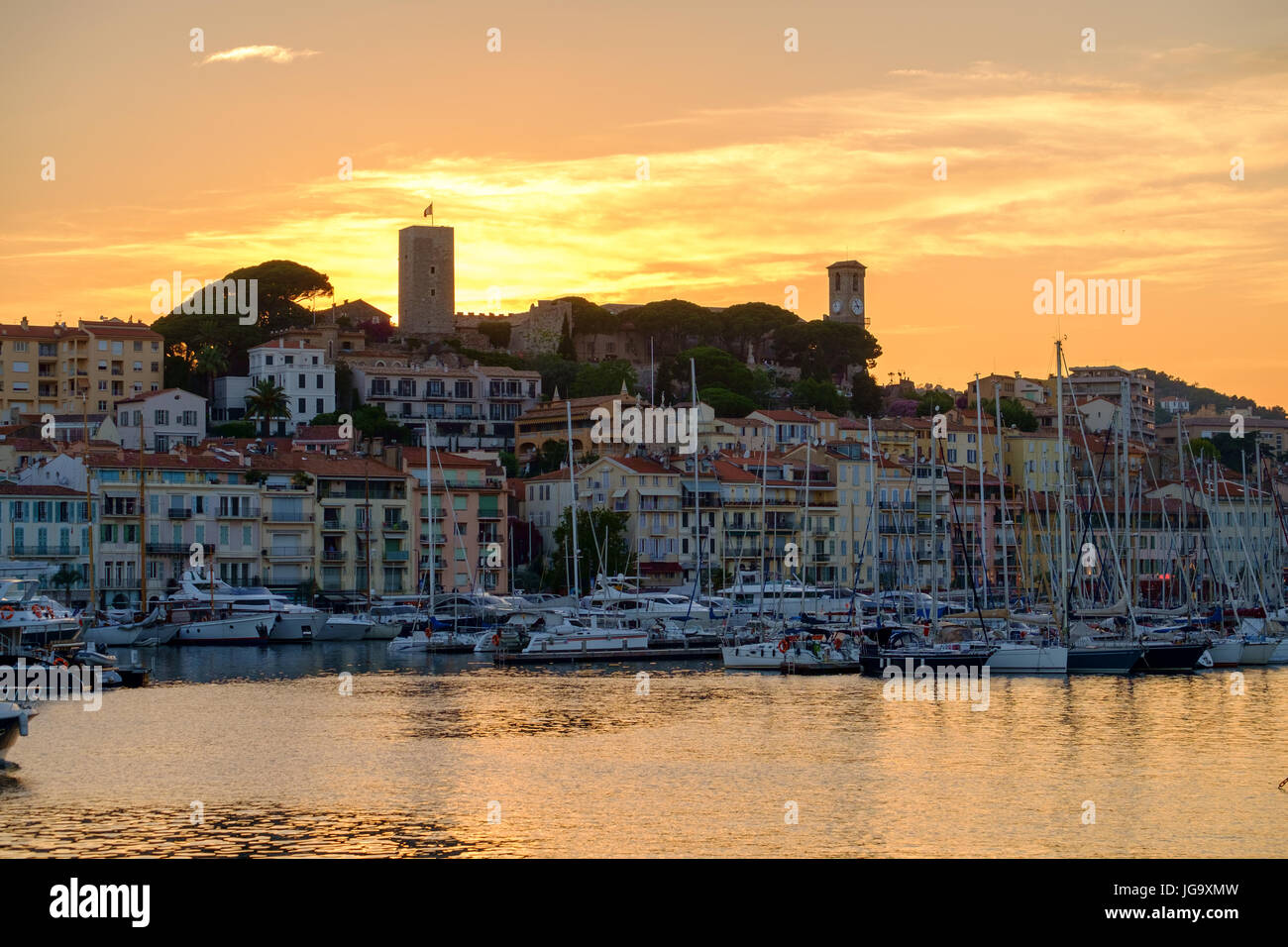 Beautiful sunset in old city and harbor in Cannes, French Riviera ...