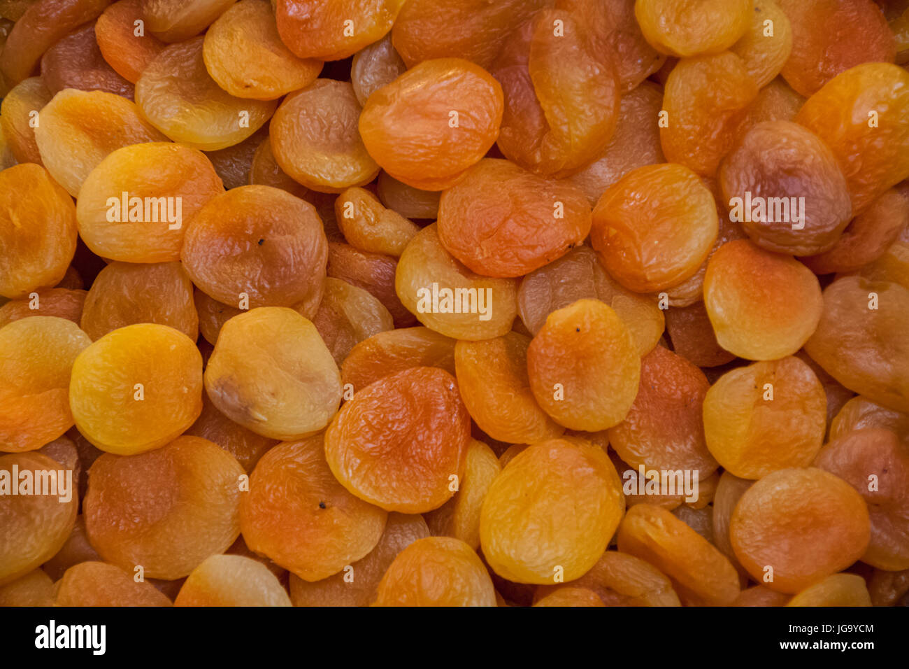 Background nuts, dried apricot, pieces piled, background of dried fruit ...