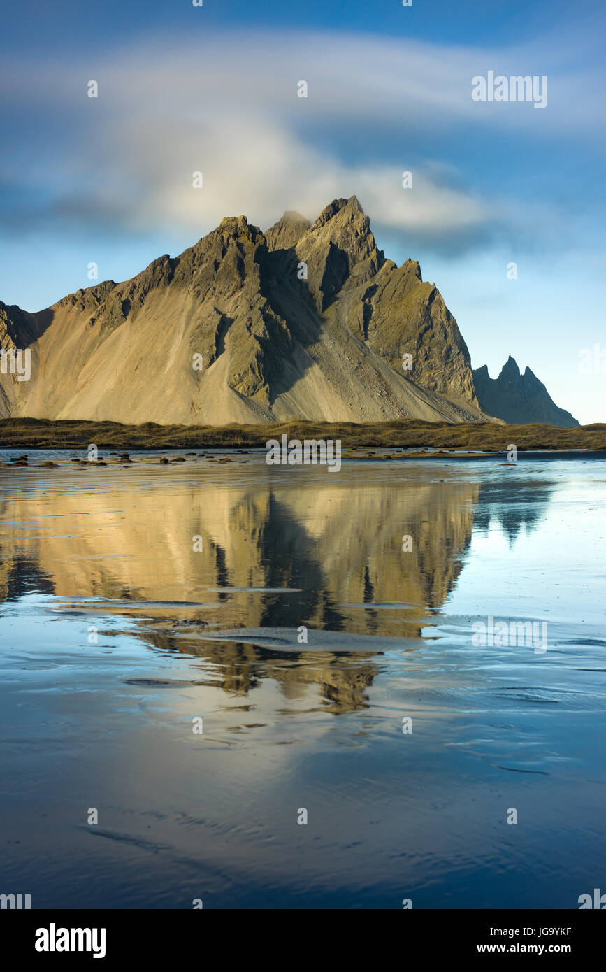 Stokksnes and Vestrahorn mountains in late afternoon light reflected in ...