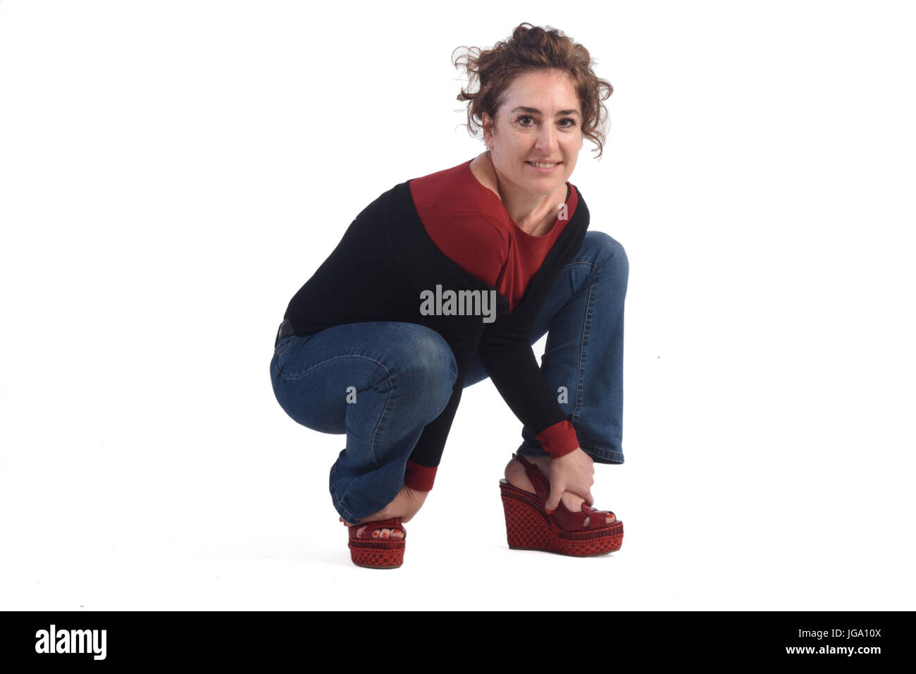Woman crouching on a white background Stock Photo - Alamy
