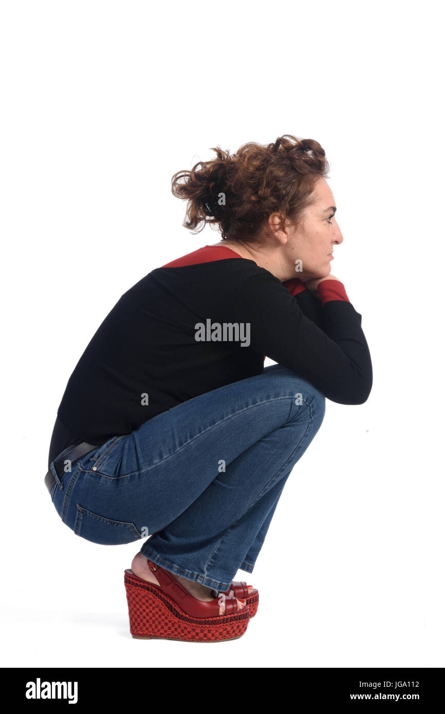 Woman crouching on a white background Stock Photo - Alamy