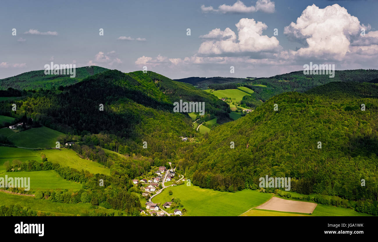 Scenic color countryside panorama of a valley with a road and green ...