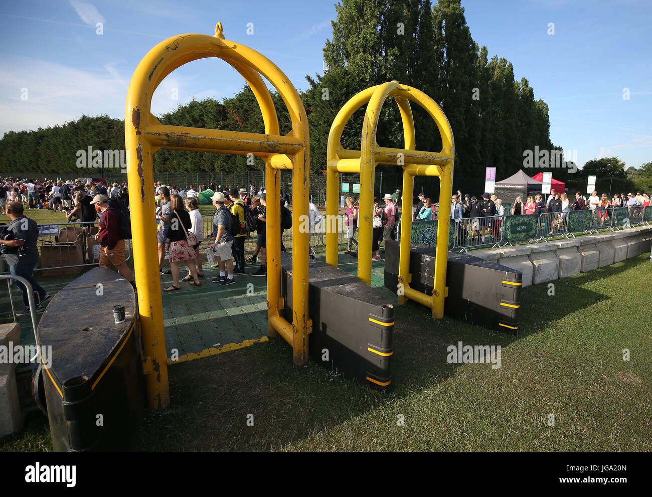 People walk past security gates in Wimbledon park during day three of ...