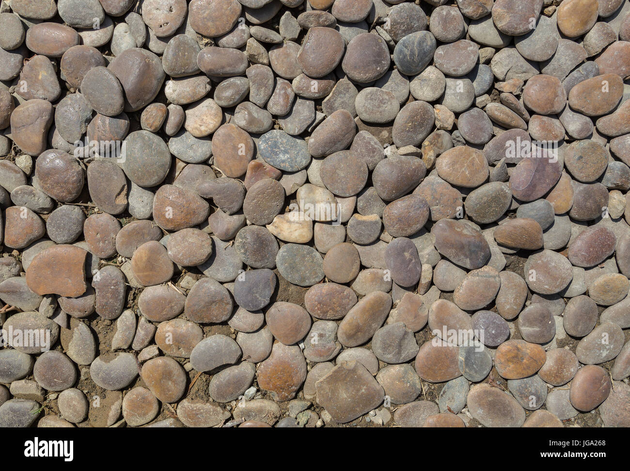 Many brown pebbles background texture Stock Photo - Alamy