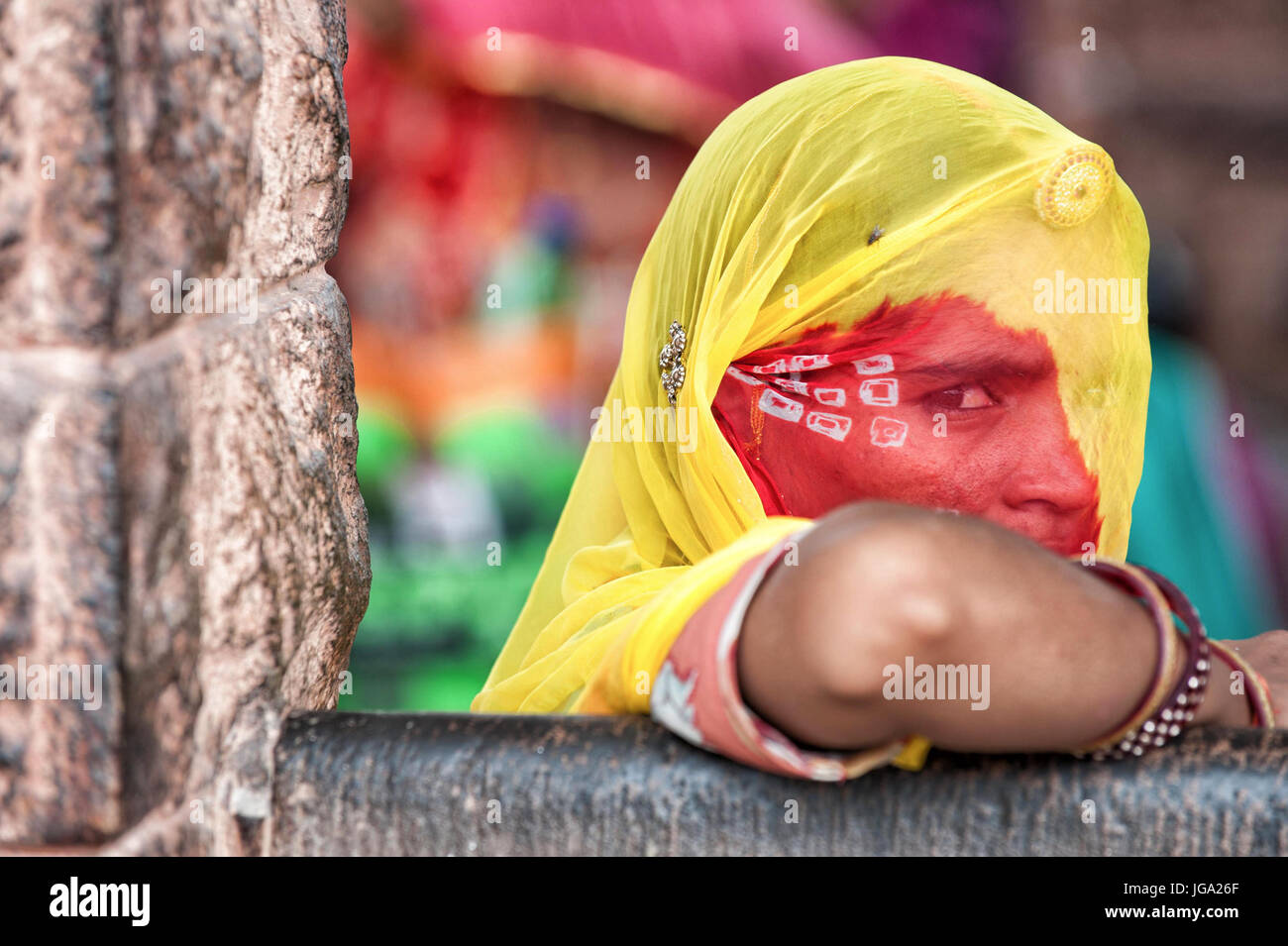 Young beautiful Indian girl waiting for the bus in traditional colored ...