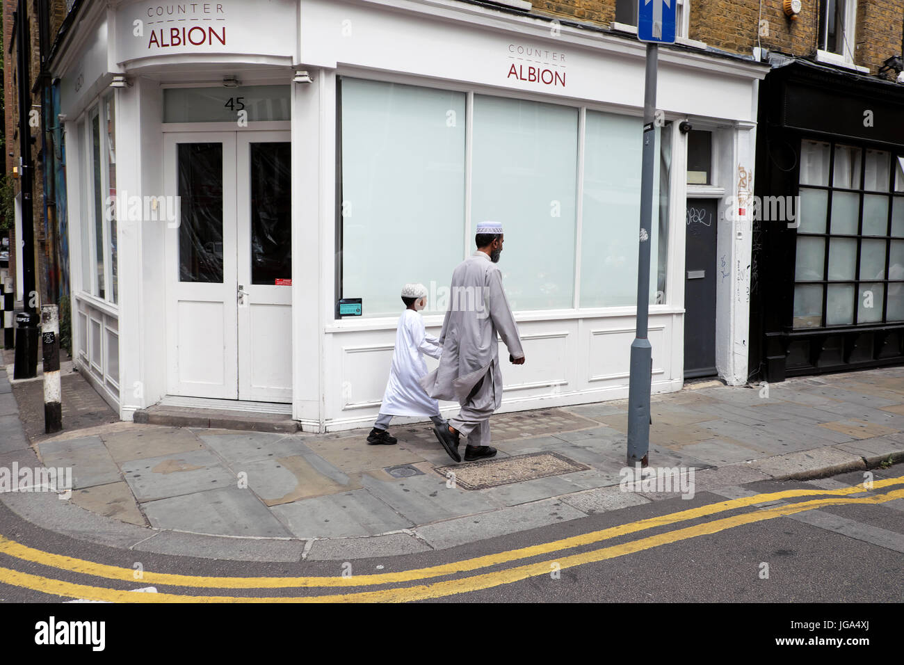 Muslim father and son walking to Redchurch Street mosque in ...