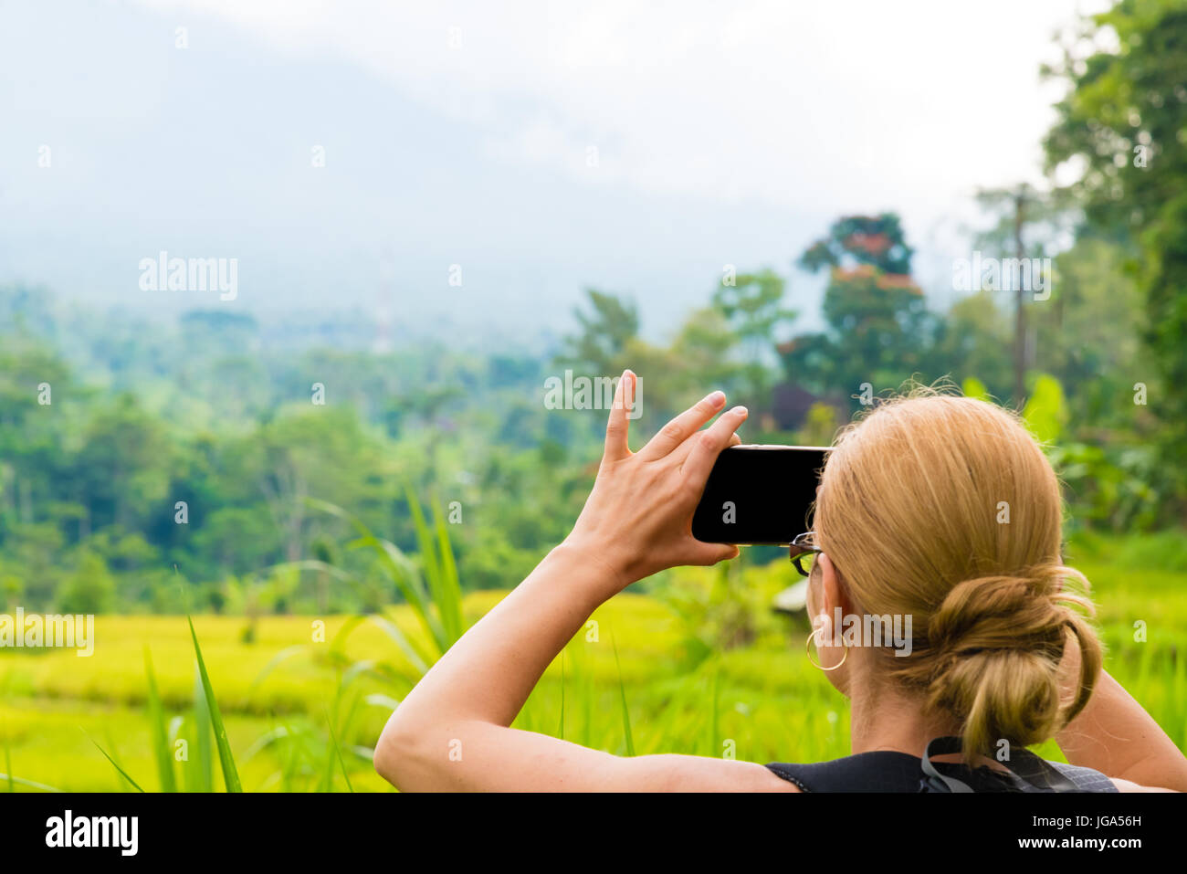 Unrecognizable young woman taking a picture with her mobile phone of ...