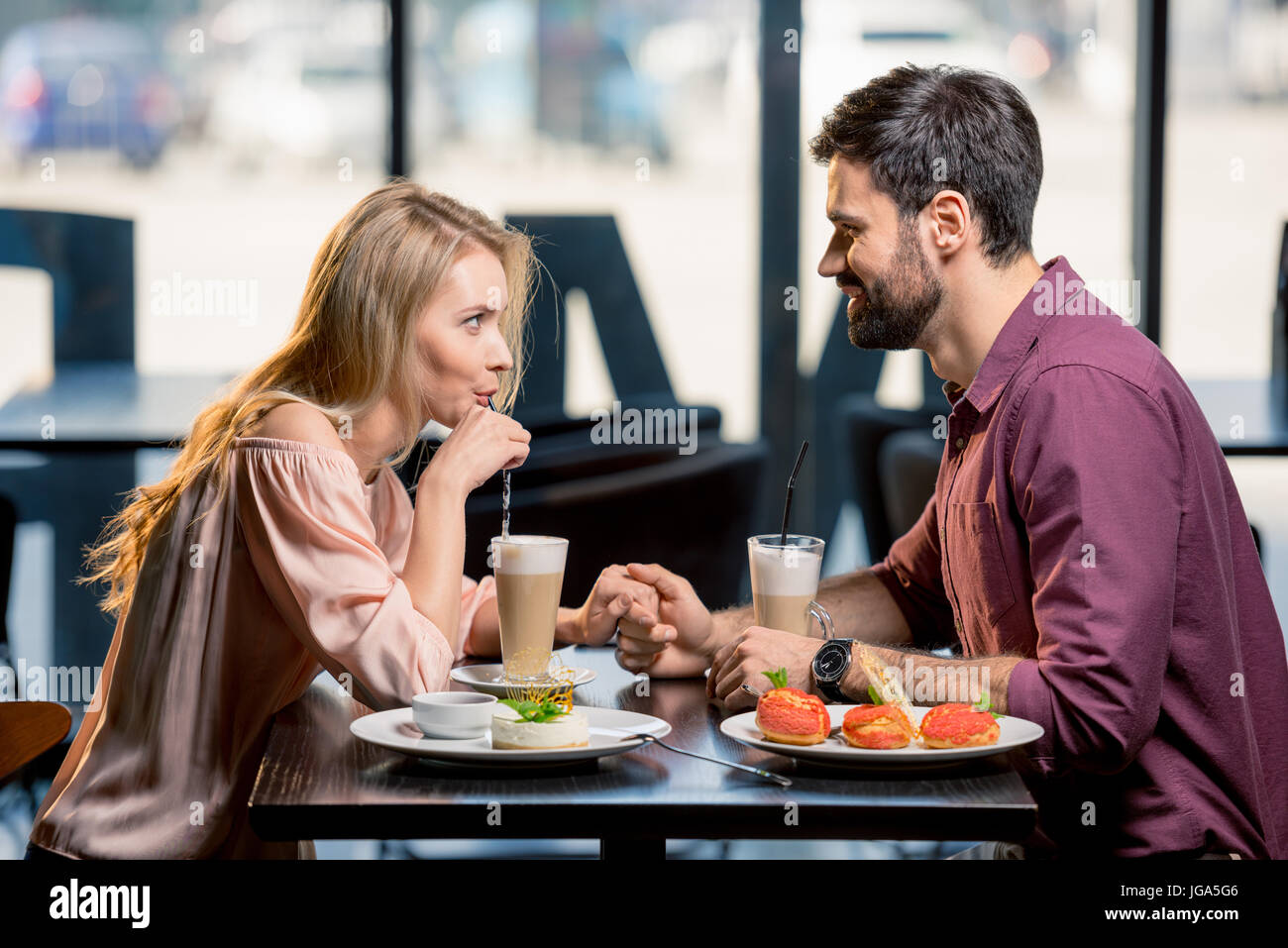 side view of couple in love having lunch together in restaurant Stock ...