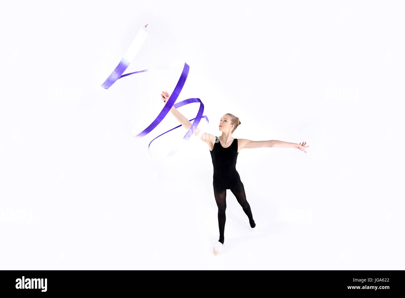 Sporty young woman doing gymnastics with ribbon isolated on white Stock ...