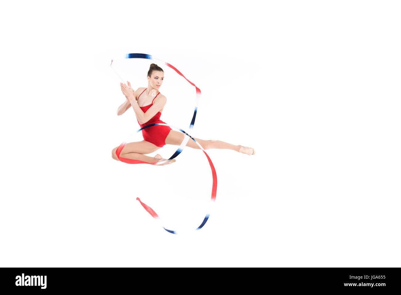 young caucasian woman rhythmic gymnast jumping with colorful rope Stock ...