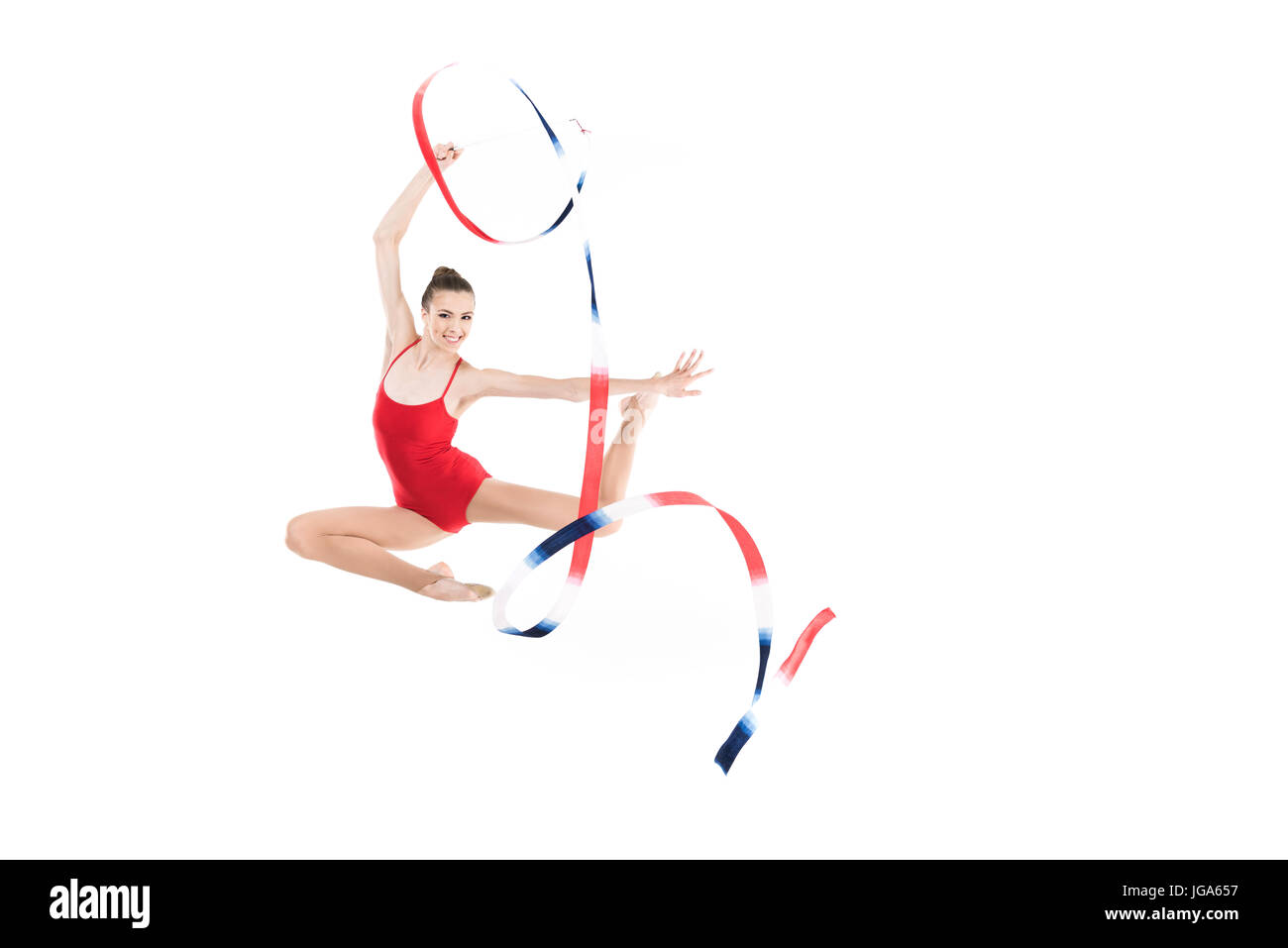 young caucasian woman rhythmic gymnast jumping with colorful rope ...