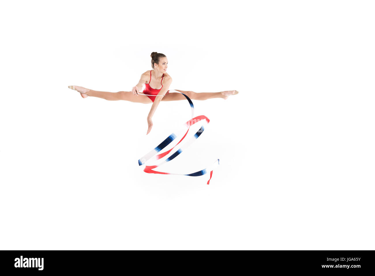young caucasian woman rhythmic gymnast jumping with colorful rope Stock ...
