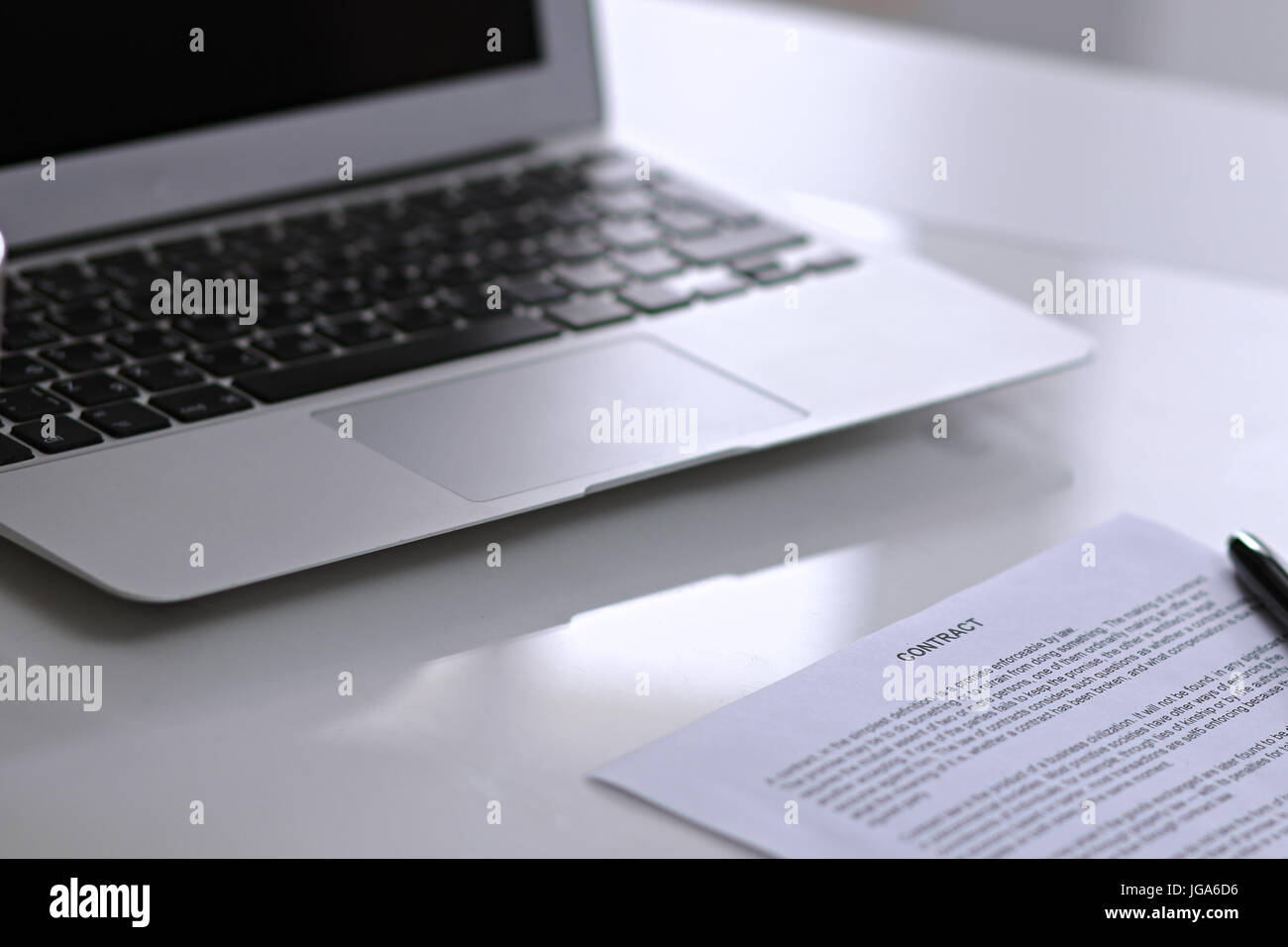 Office workplace with a laptop and contract document Stock Photo - Alamy