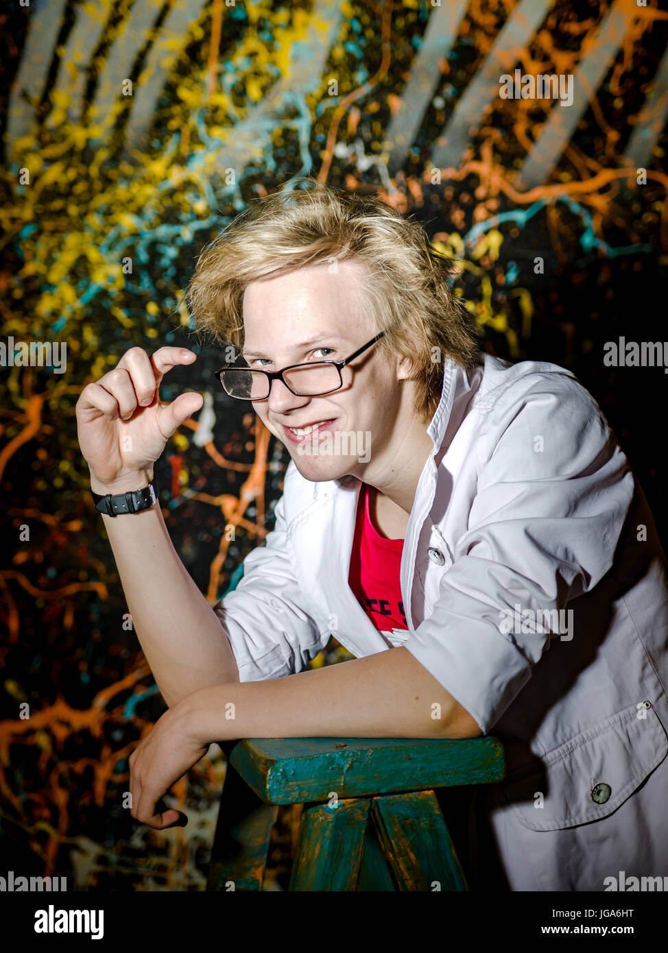 Funny teenage boy posing like a crazy professor or student, expressive ...