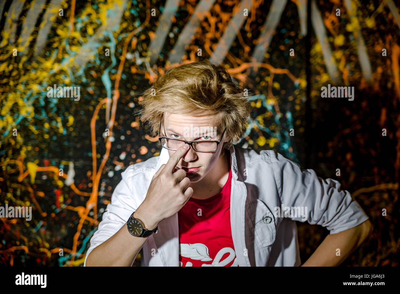 Funny teenage boy posing like a crazy professor or student, expressive ...