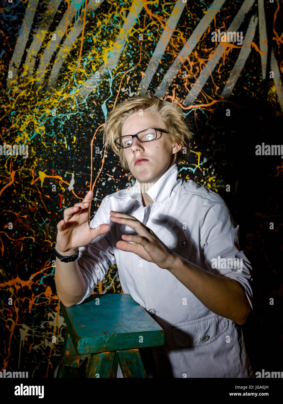 Funny teenage boy posing like a crazy professor or student, expressive ...