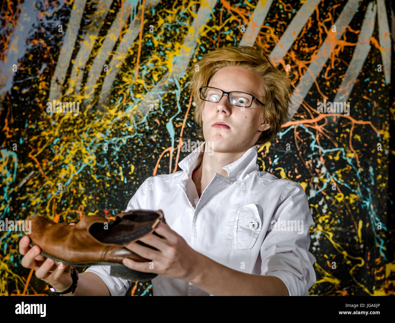 Funny teenage boy posing like a crazy professor or student, expressive ...