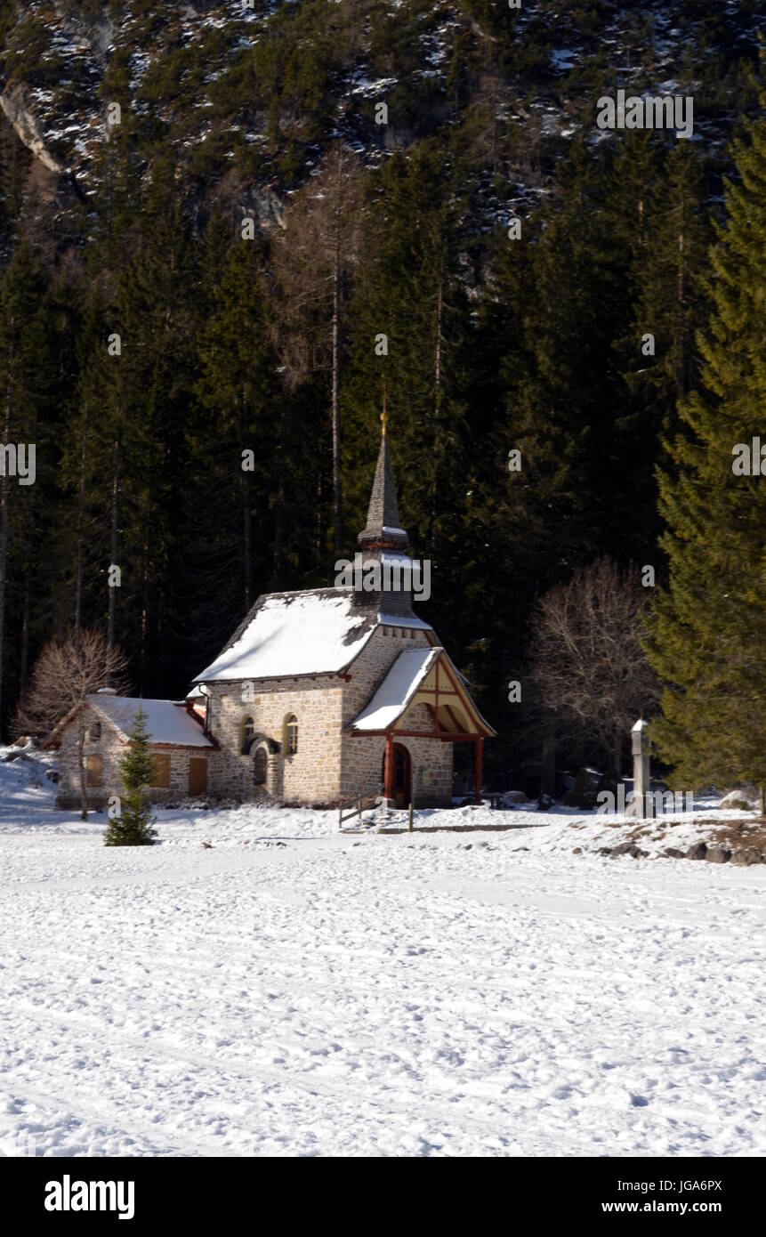 Alpine church near Braies lake along the walkway between the forest in ...