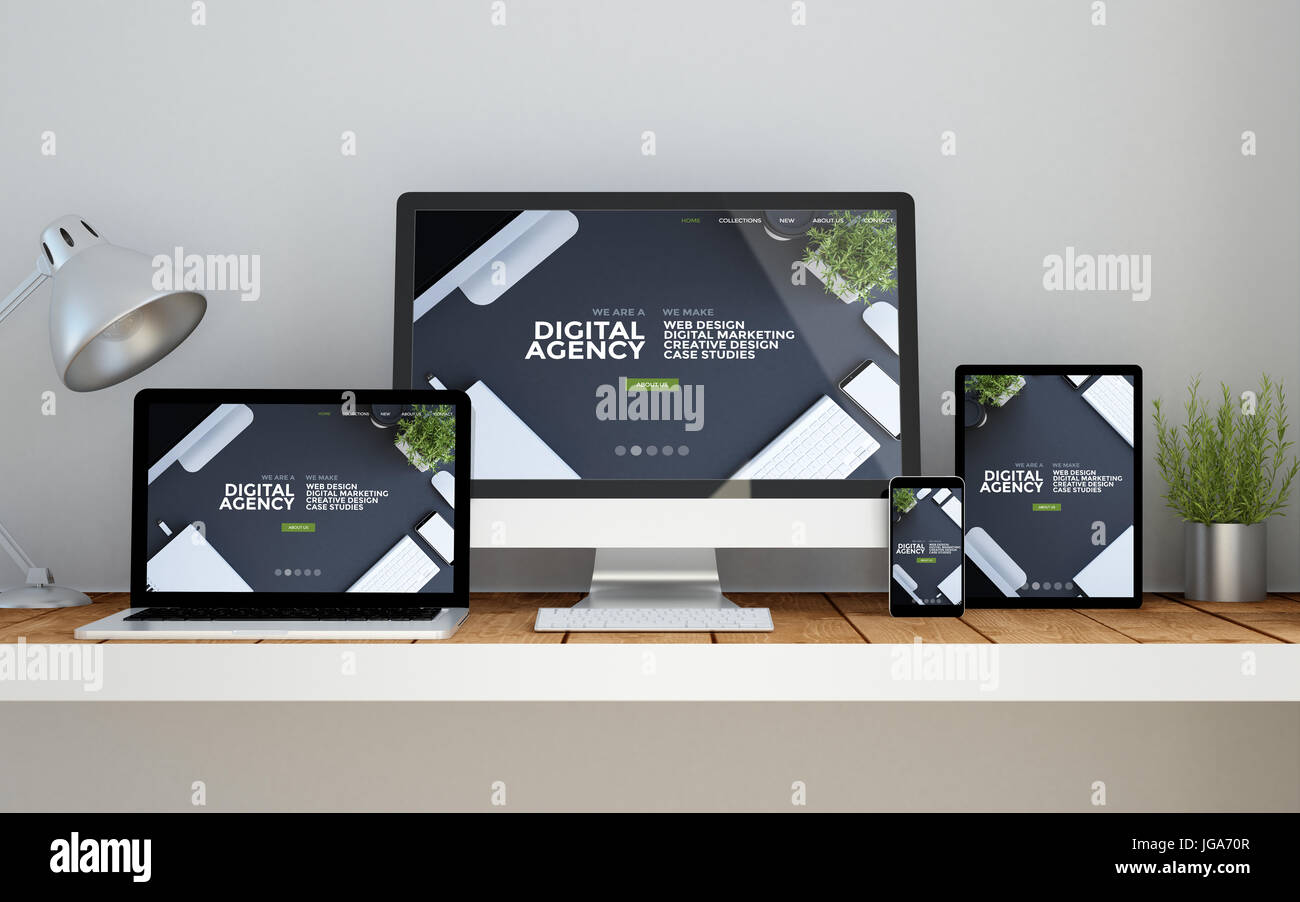 A computer, laptop, smartphone and tablet on a desktop workspace with ...