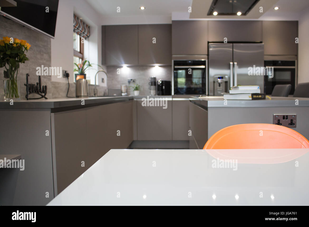 A modern, luxury, matt grey kitchen interior showing a centre island ...