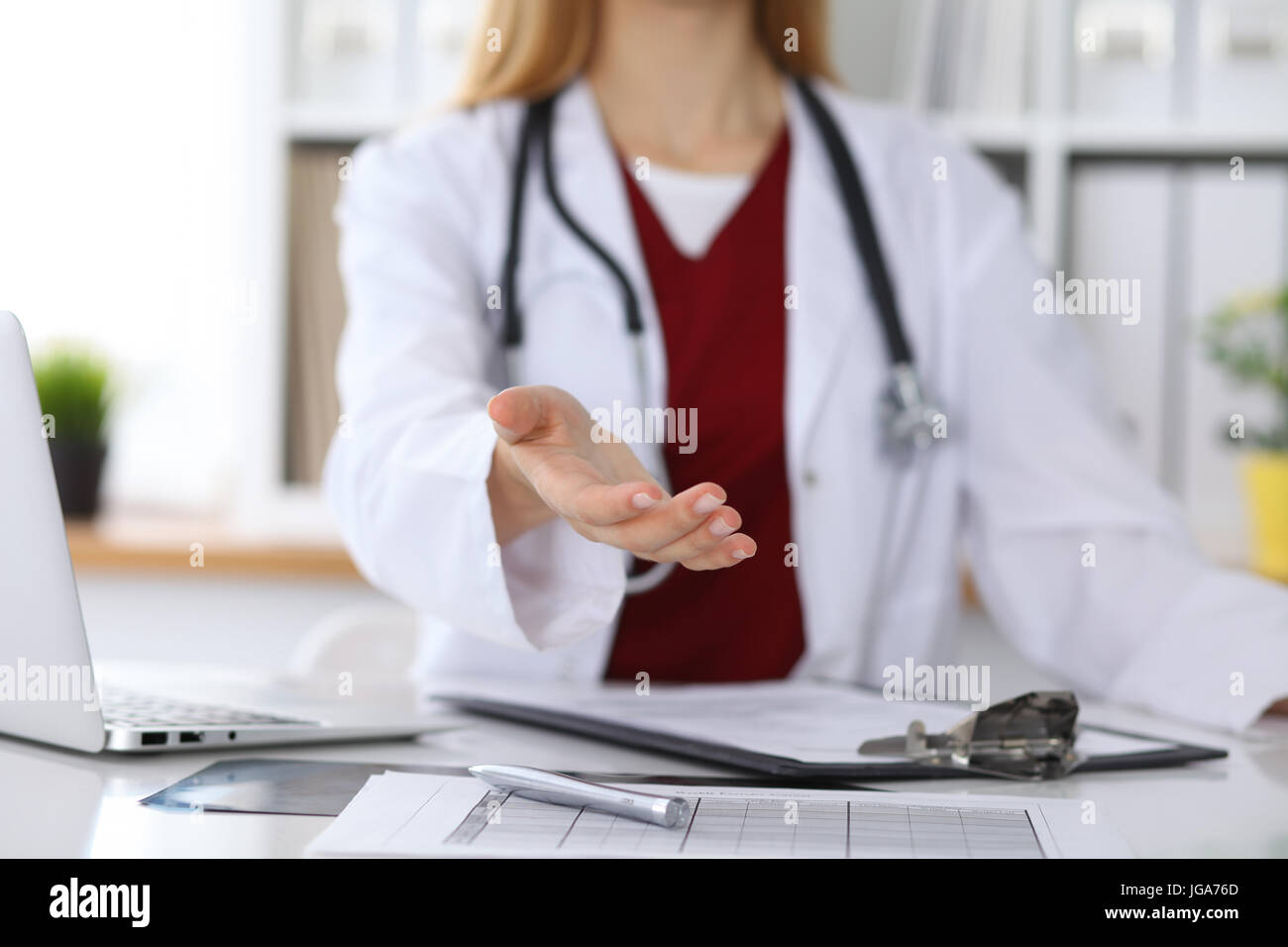 Female medicine doctor offering helping hand in office closeup ...