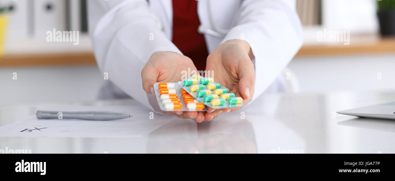 Female doctor hand holding pack of different tablet blisters at ...