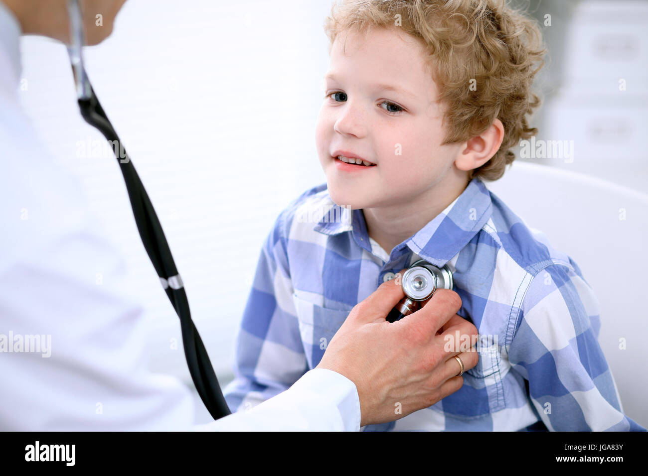 Doctor examining a child patient by stethoscope Stock Photo - Alamy