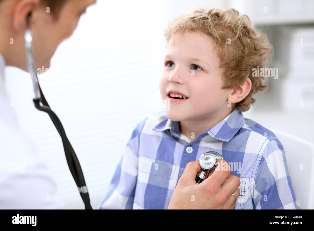 Doctor examining a child patient by stethoscope Stock Photo - Alamy