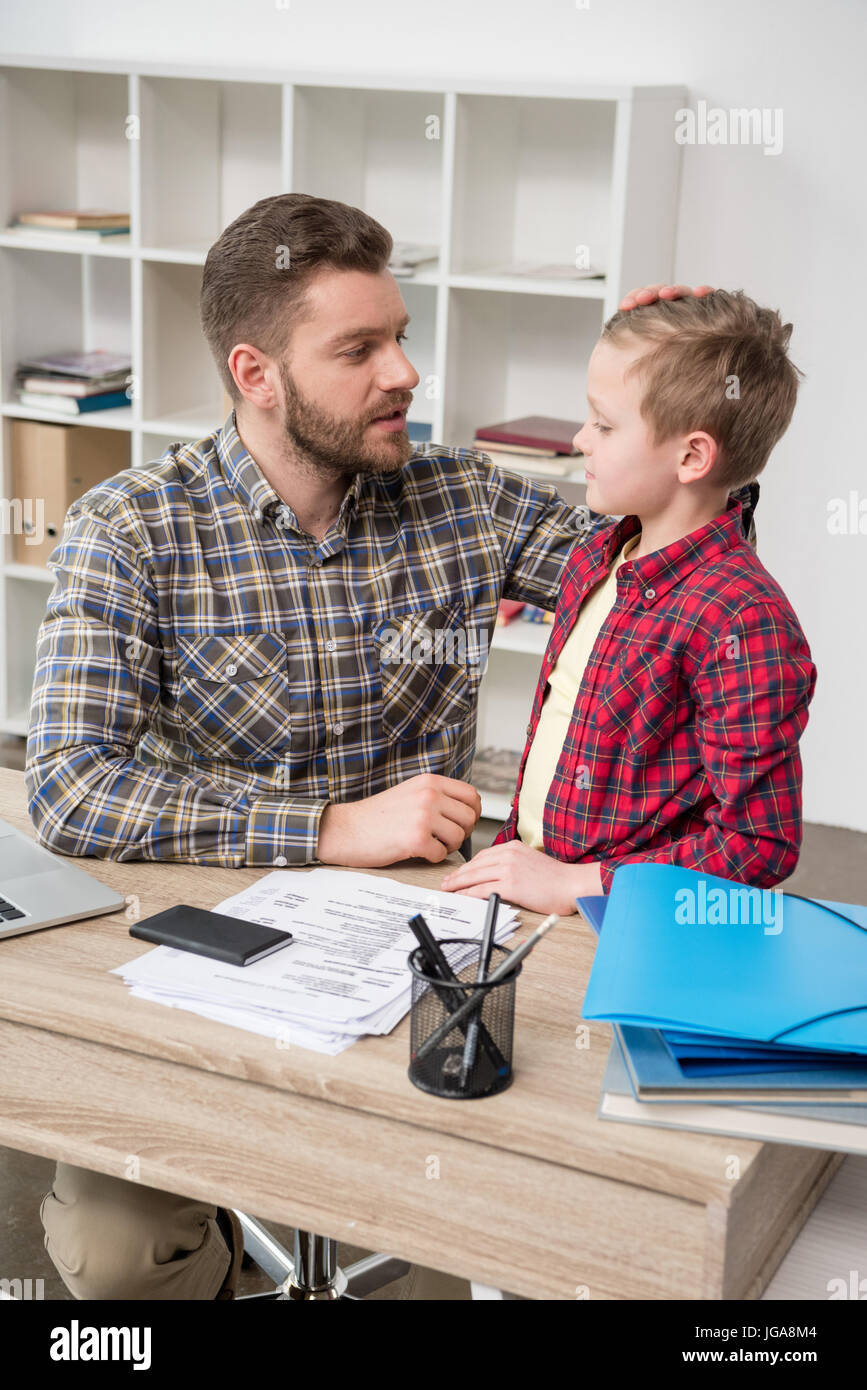 Father businessman hugs his son at home office Stock Photo - Alamy