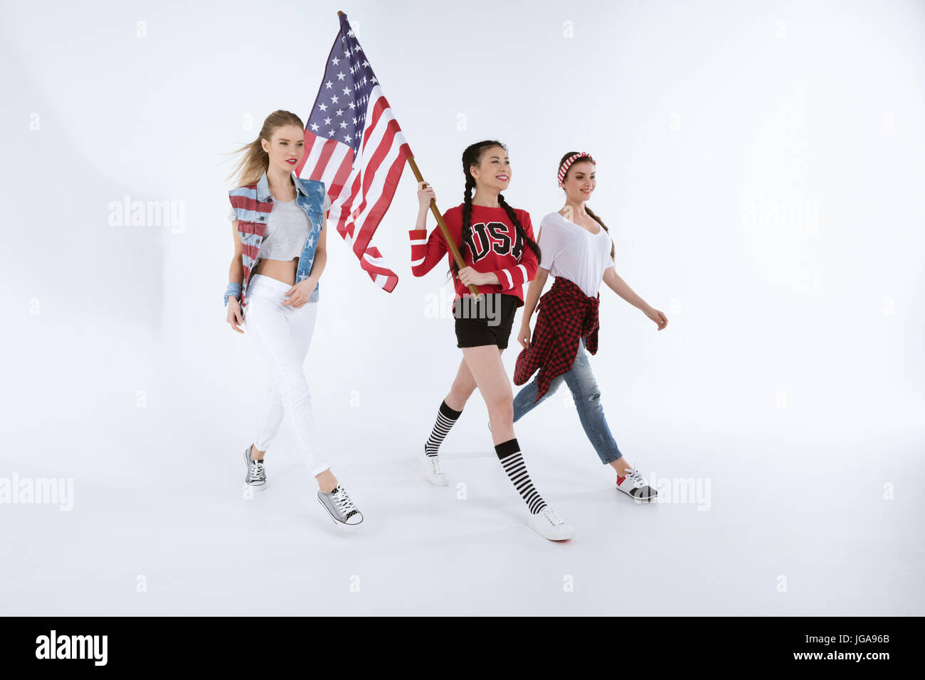 multiethnic girls walking with american flag and celebrating 4th july ...