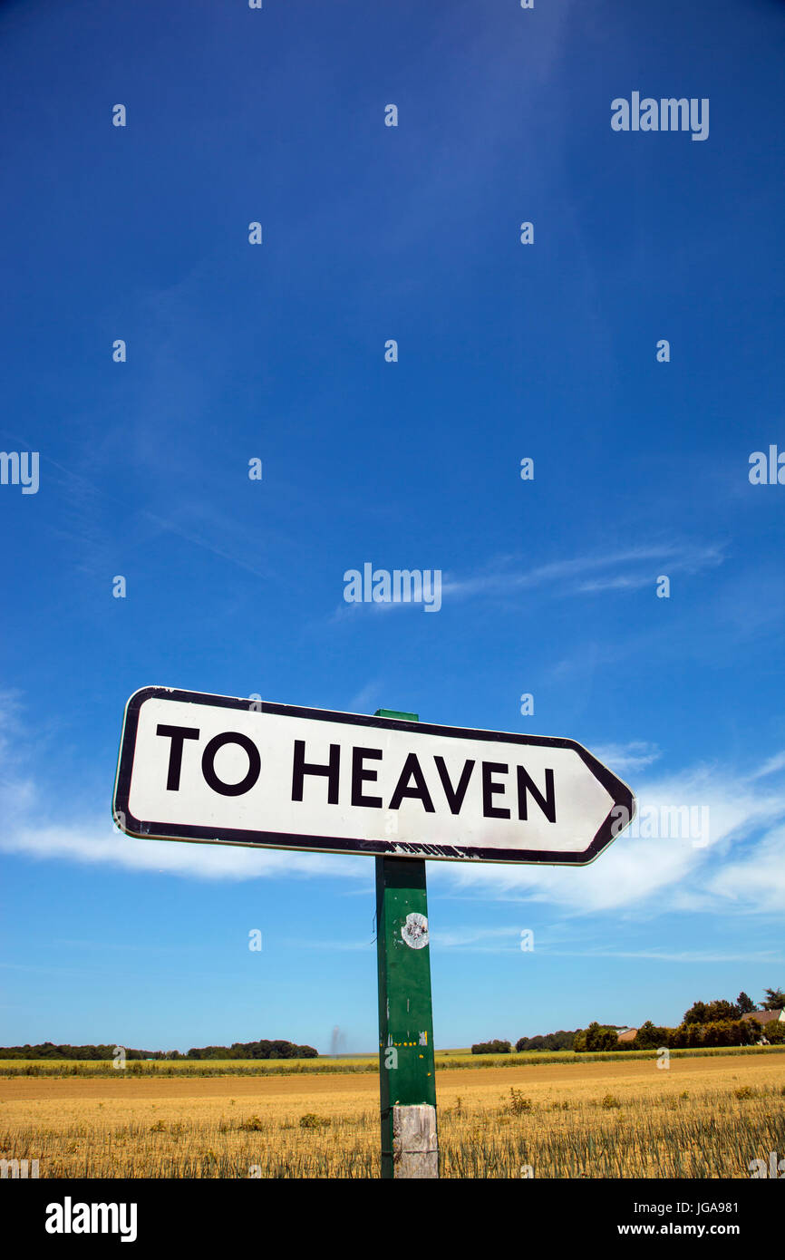 In the countryside a road sign with the inscription heaven, with a blue ...