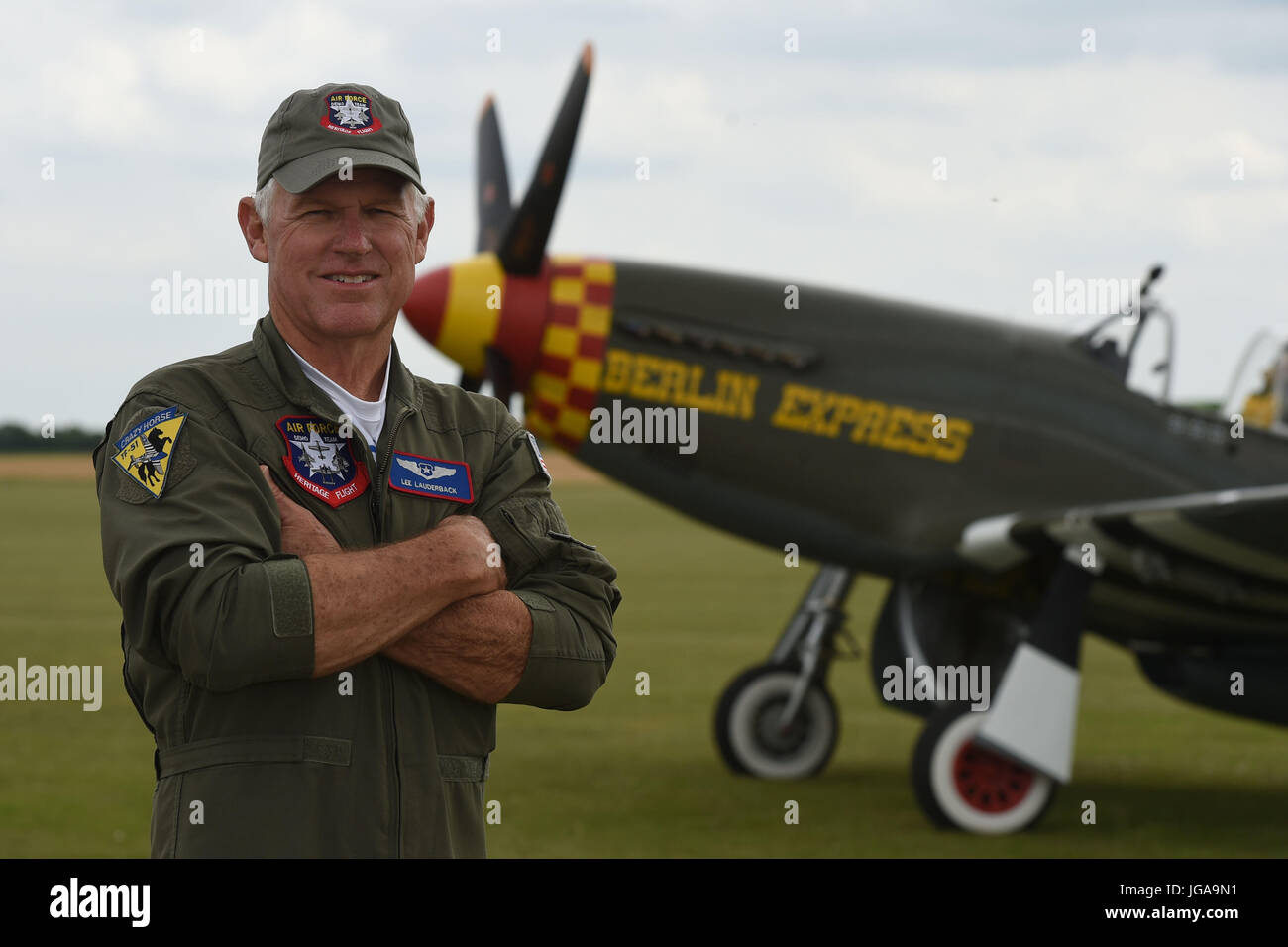 Pilot Lee Lauderback stands beside a P-51 Mustang Berlin Express at the ...