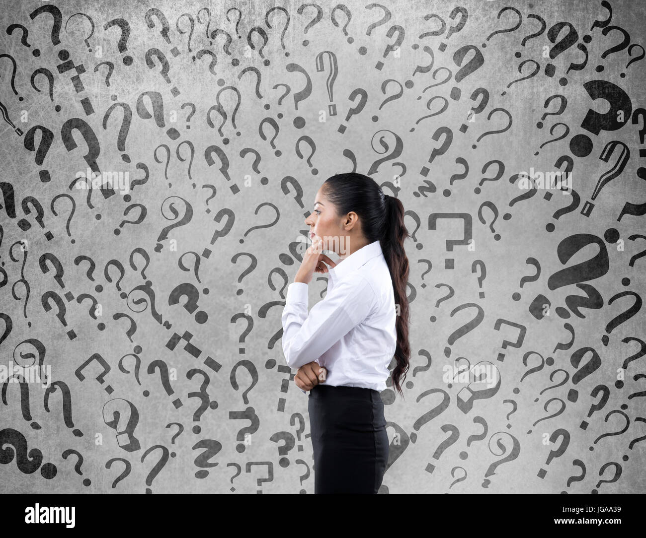 Side view of confused businesswoman with question marks on wall Stock ...