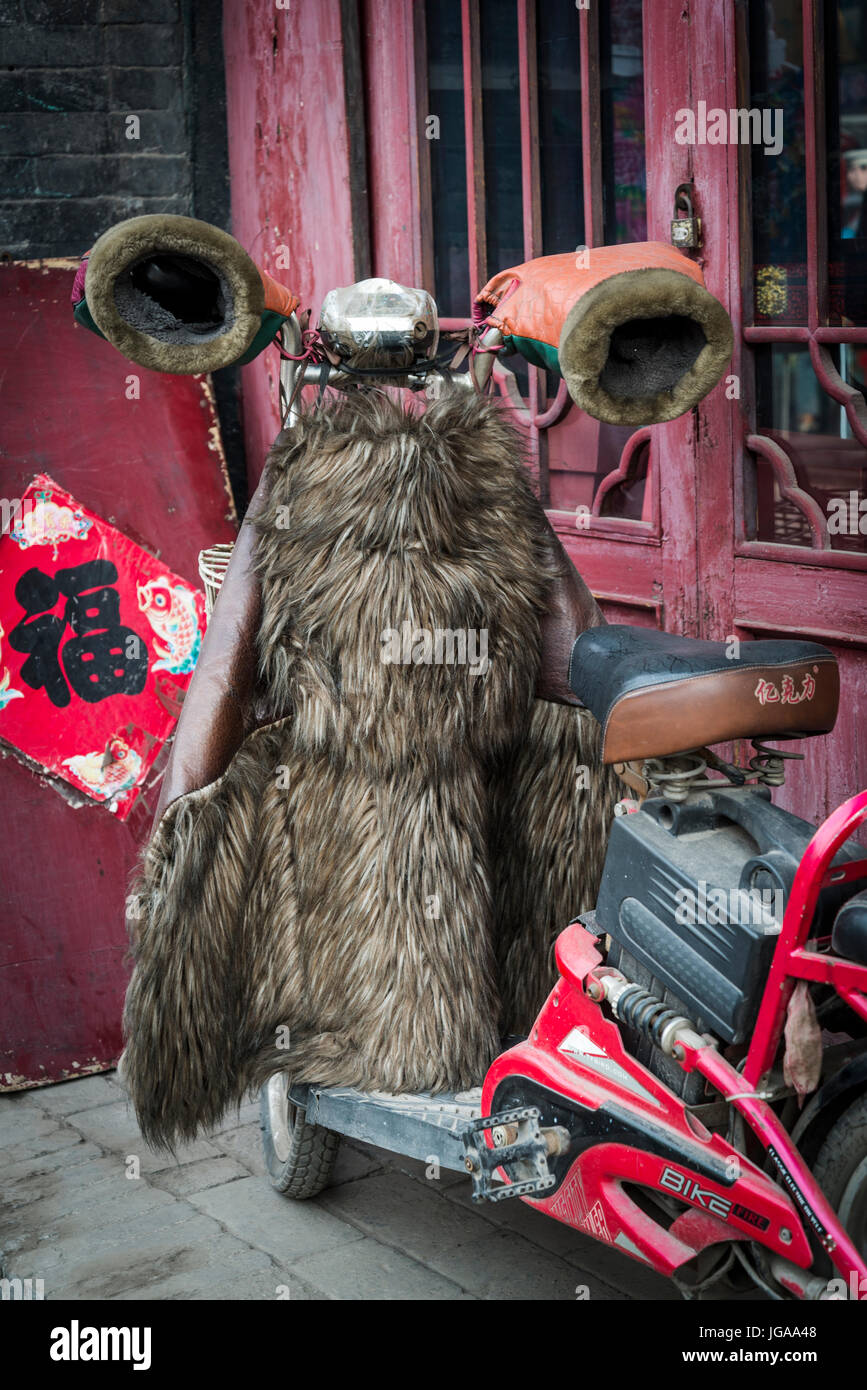 Scooter with a fur protection from wind and cold, China Stock Photo - Alamy