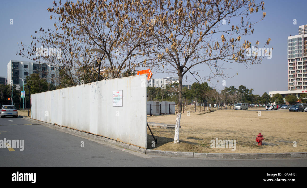 Composite fence panels fixed to angle iron supports around worksite ...