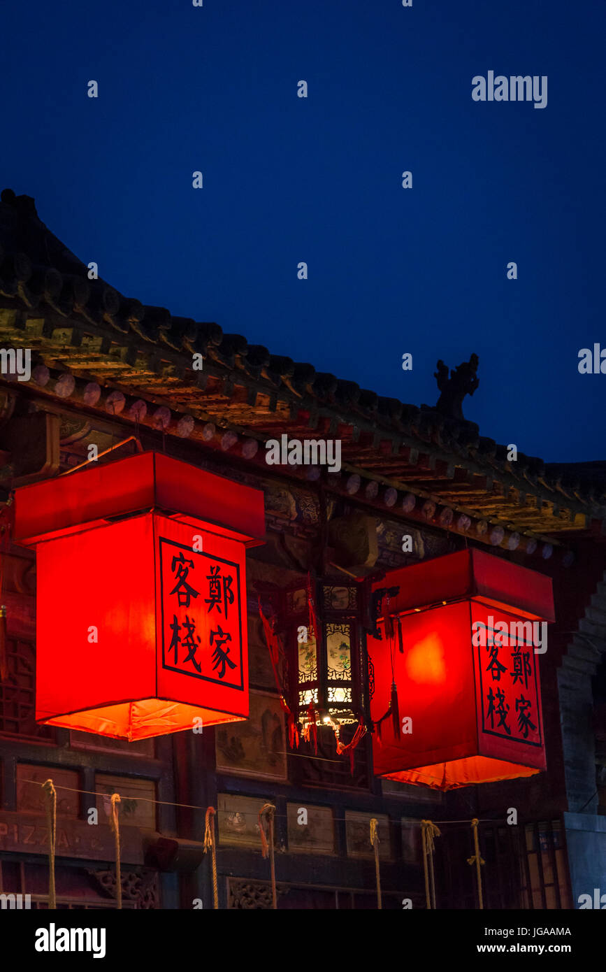 Illuminated traditional Chines lanterns hanging in front of a house ...
