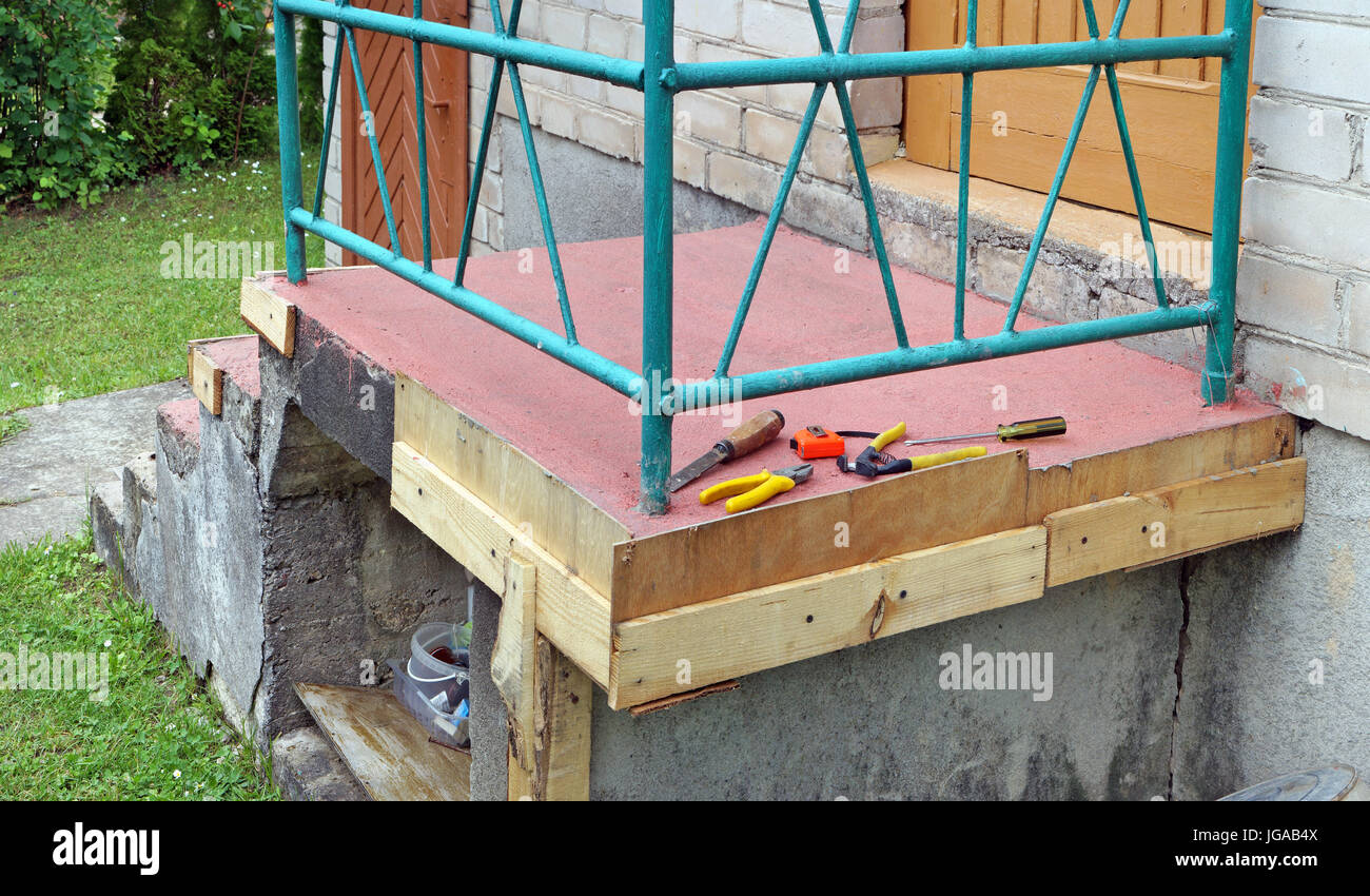Unprofessional homemade repair of the destroyed concrete porch in a ...