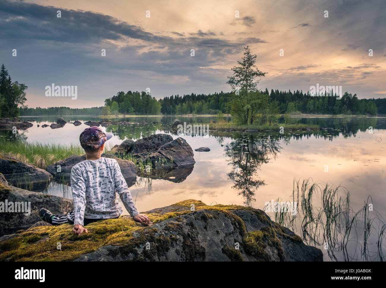Boy sitting on stone hi-res stock photography and images - Alamy