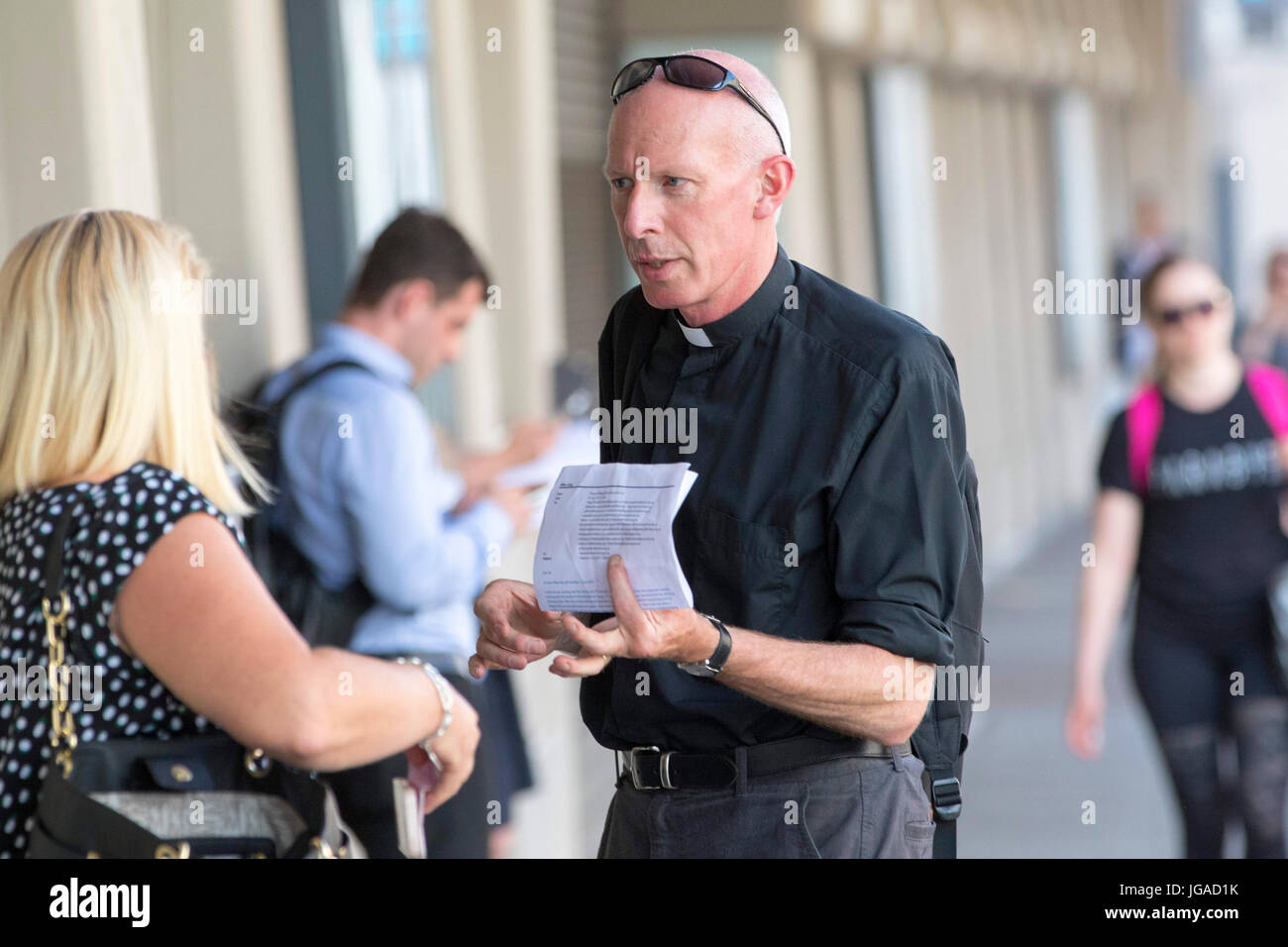 A priest arrives at Kensington Olympia in west London to attend a ...