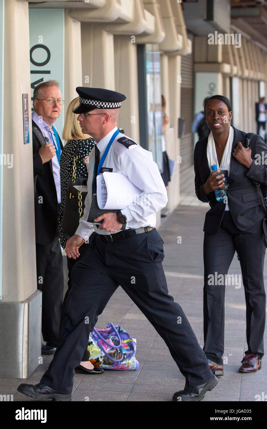 Police officers arrive at Kensington Olympia in west London to attend a ...