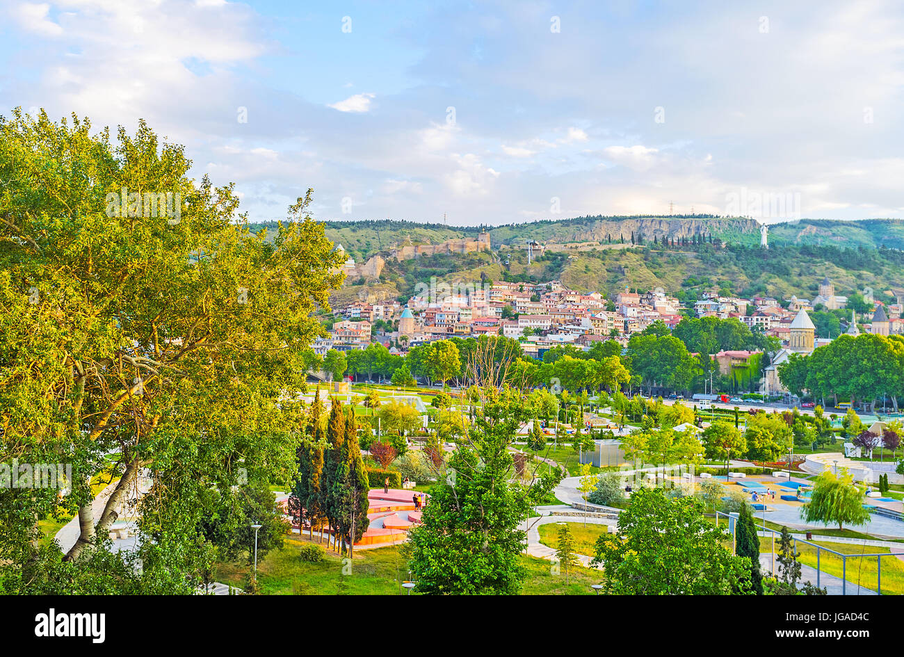 The old town on Sololaki Hill behind the lush greenery of Rike Park ...