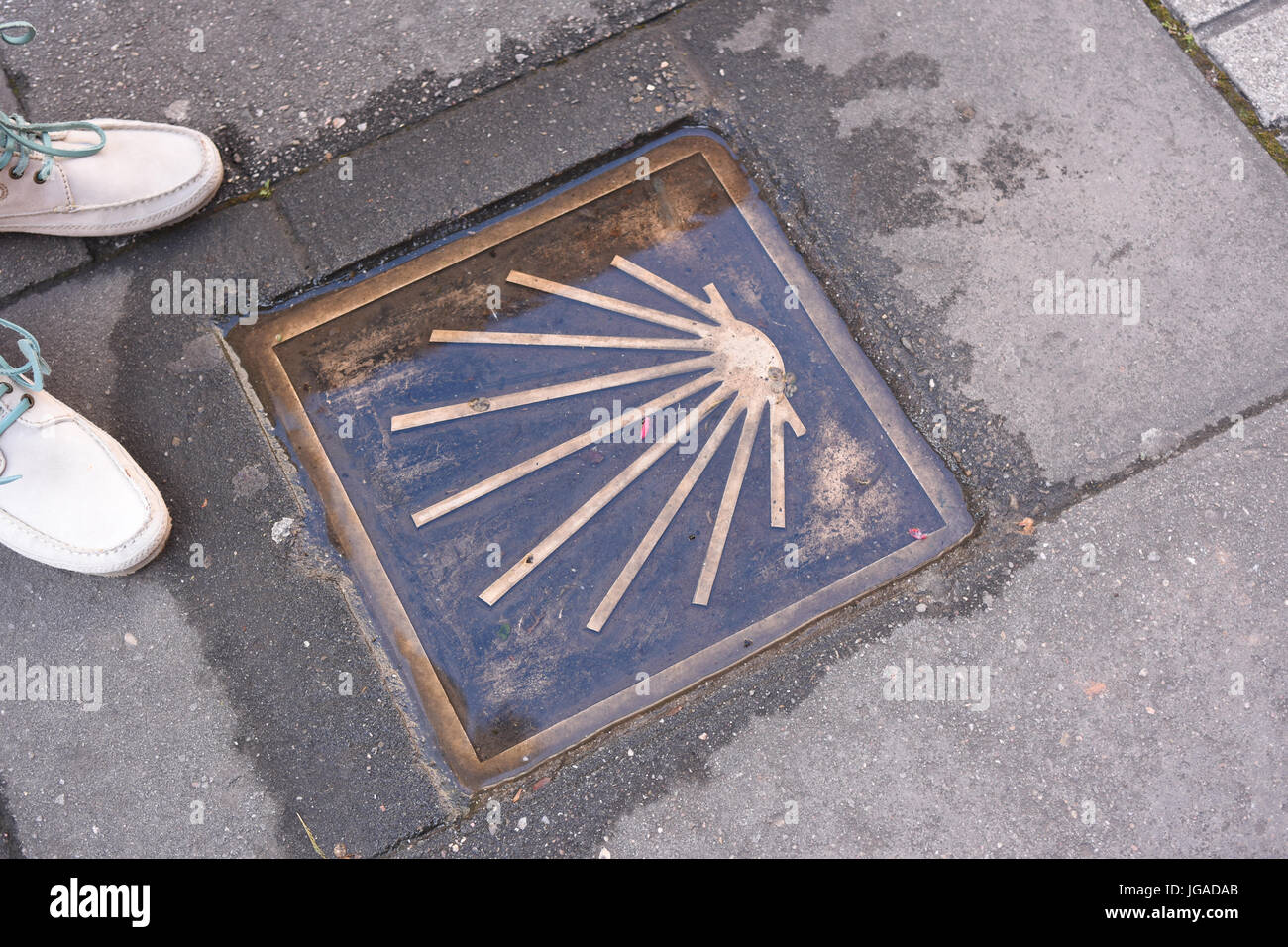Shell and shoes on the floor of the road to Santiago, Najera, La Rioja ...